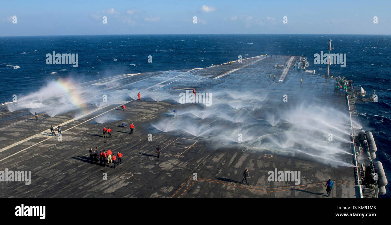 Sailors test sprinklers on the flight deck during a counter measure ...