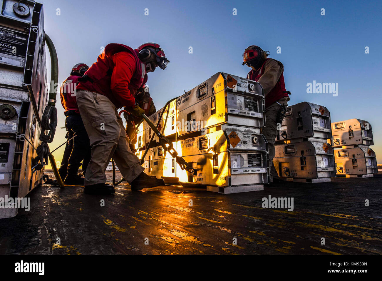 -Sailors attach cargo ropes to ordnance crates on the flight deck of ...