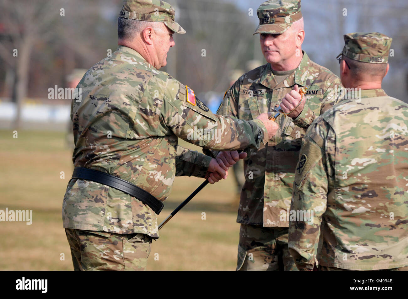 Command Sgt. Maj. Kevin J. Stallings receives a saber from Maj. Gen ...