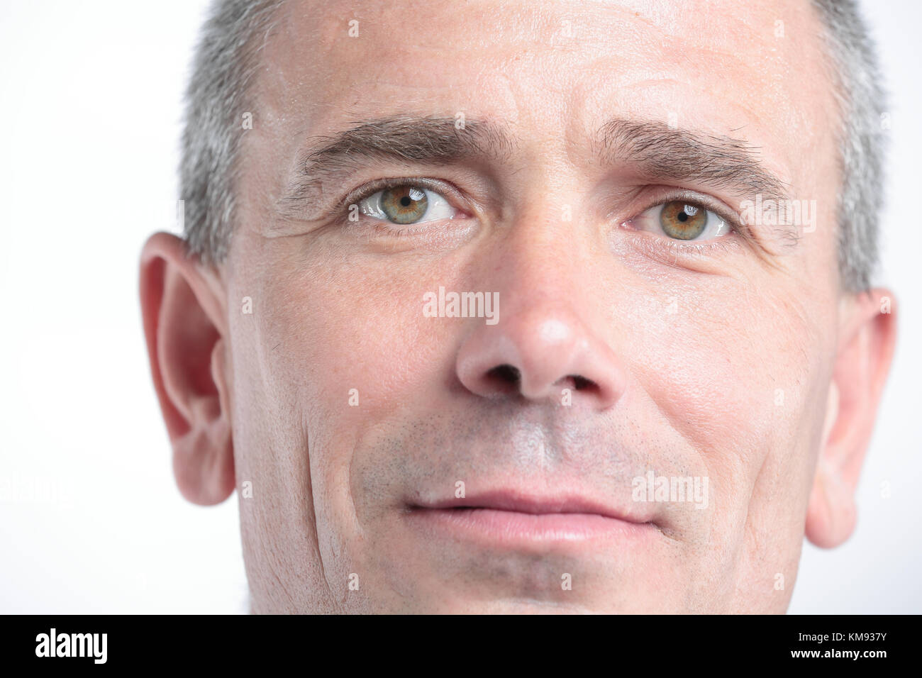 Portrait of successful mature business man smiling against white Stock ... Portrait of successful mature business man smiling against white Stock ...