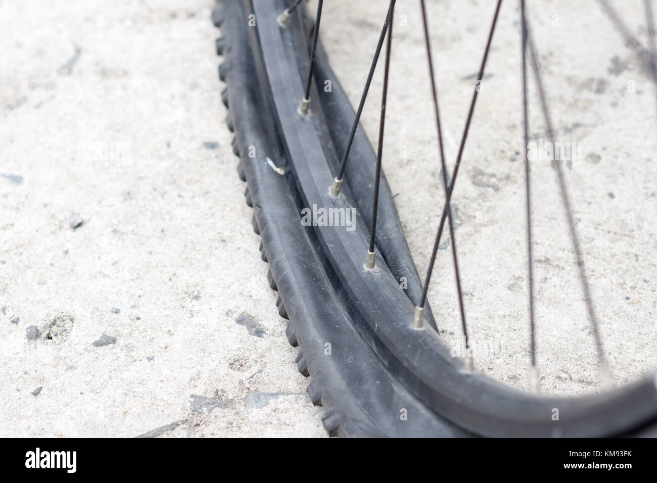 Closeup view of bicycle flat tire on pavement Stock Photo - Alamy