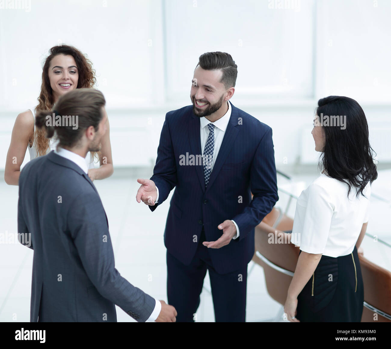 business team talking, standing in office Stock Photo - Alamy
