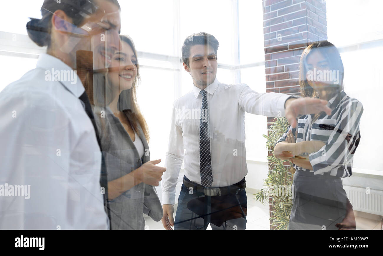 from behind the glass.business team in the officce Stock Photo - Alamy