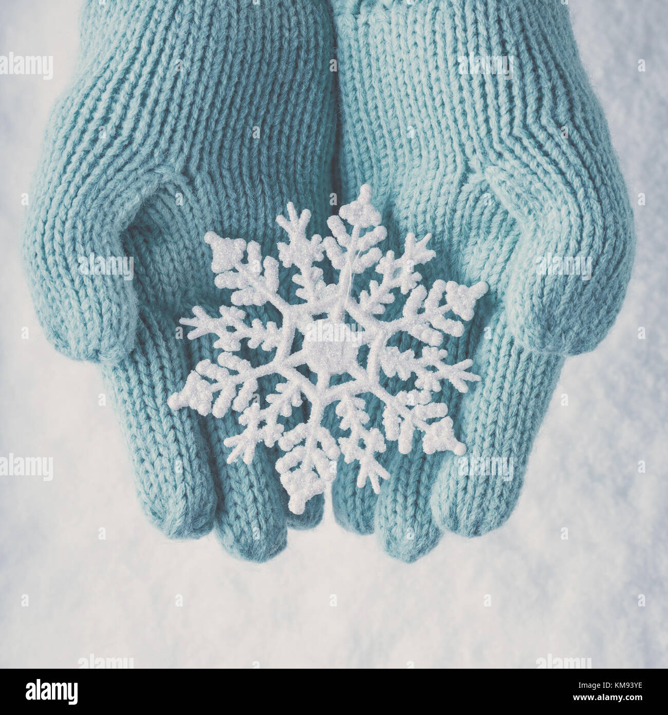 Female hands in light teal knitted mittens with sparkling wonderful ...