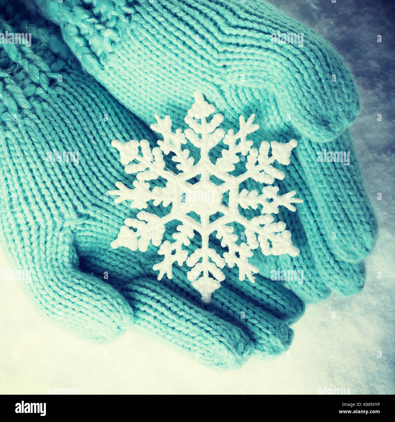 Female hands in light teal knitted mittens with sparkling wonderful ...