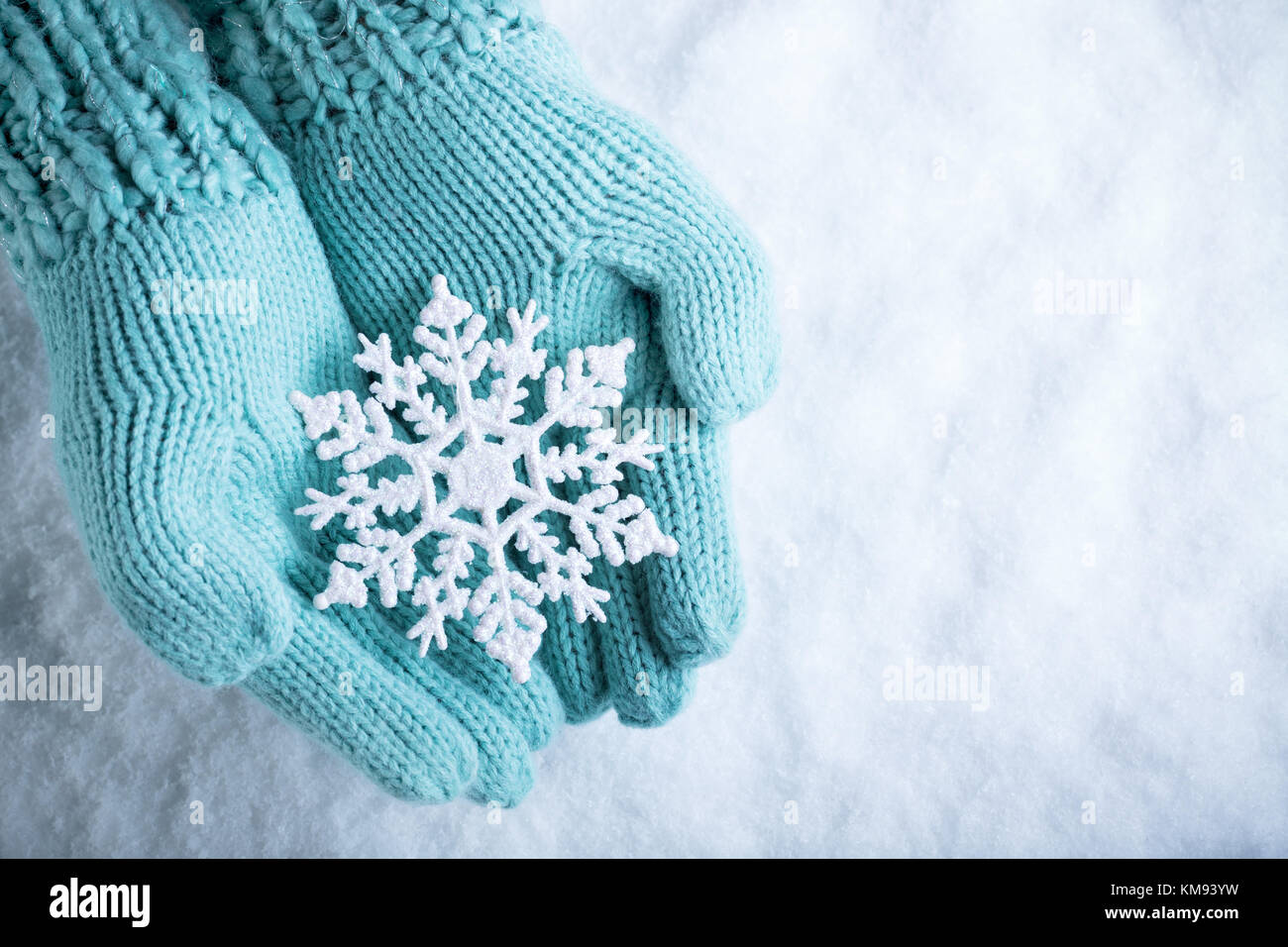Female hands in light teal knitted mittens with sparkling wonderful ...