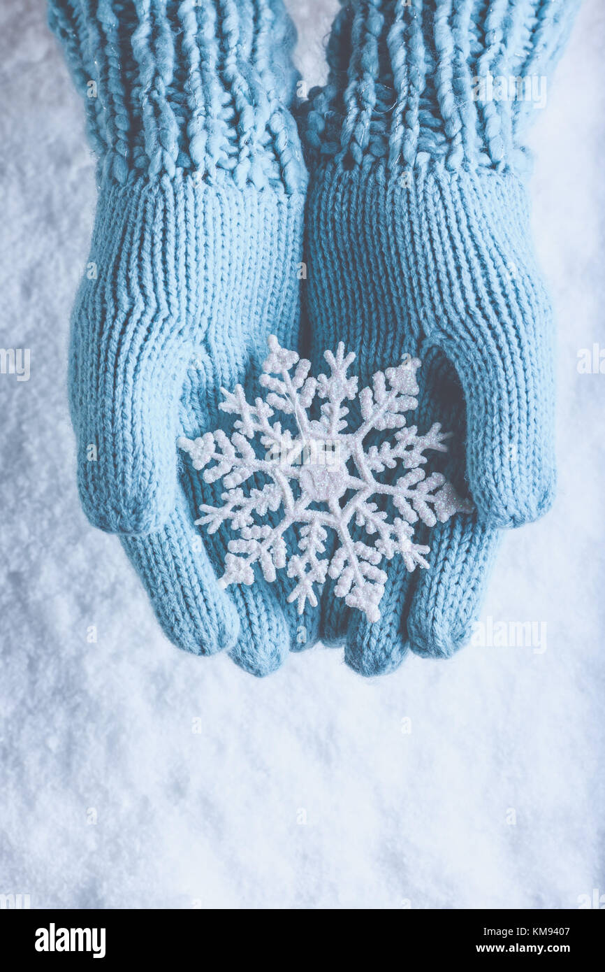 Female hands in light teal knitted mittens with sparkling wonderful ...