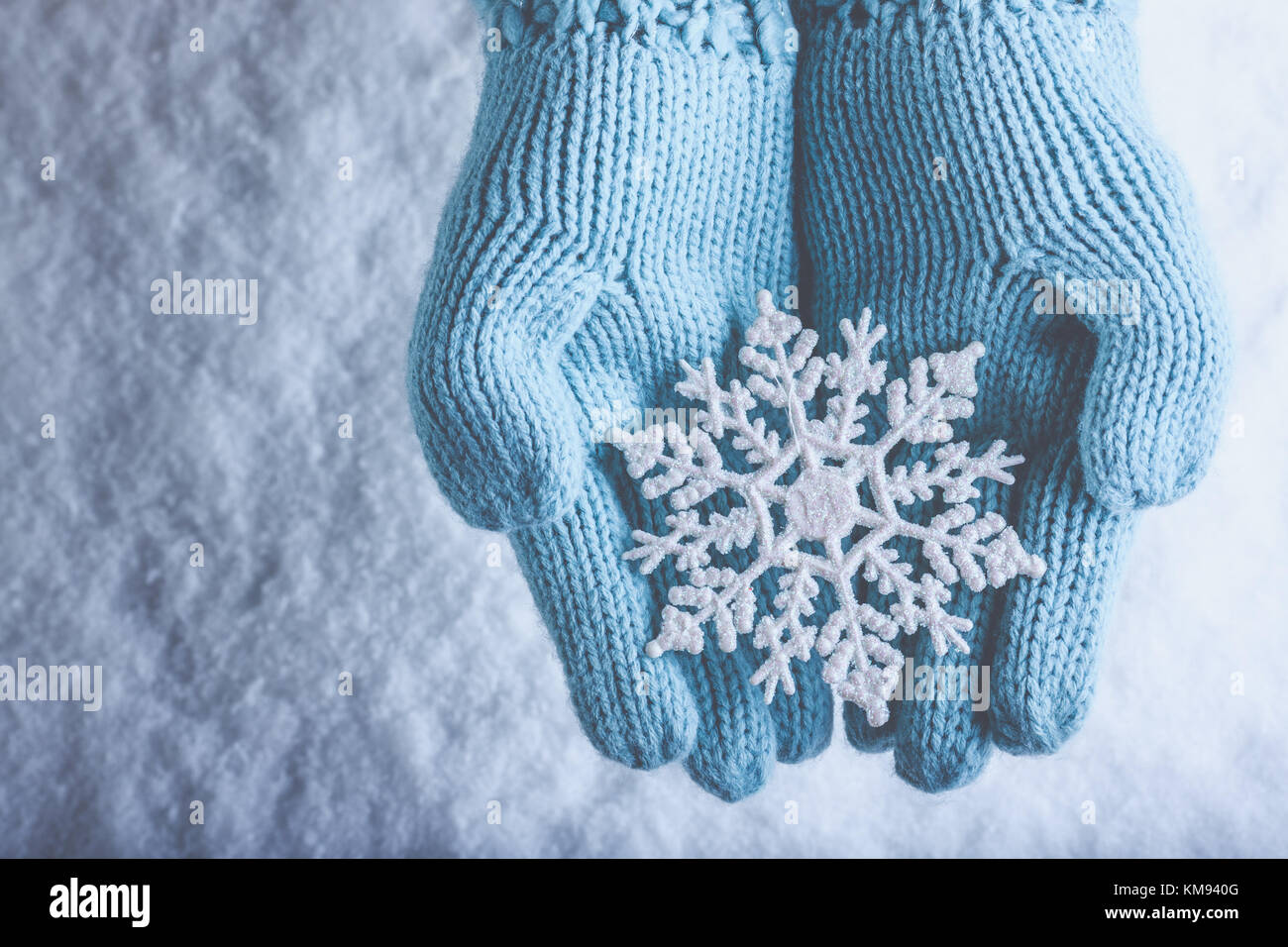 Female hands in light teal knitted mittens with sparkling wonderful ...