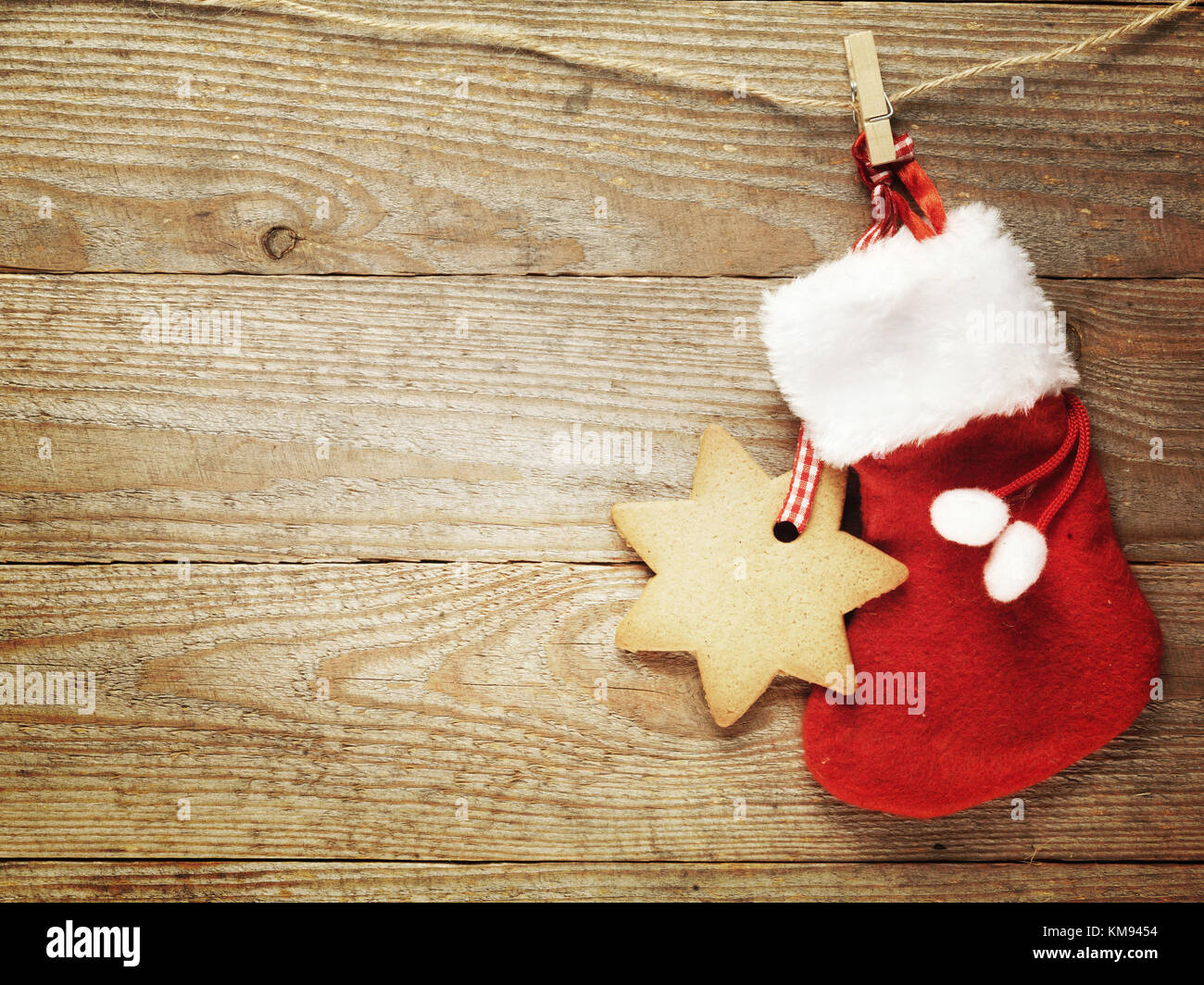 Gingerbread cookies and christmas decorations hanging over wooden ...
