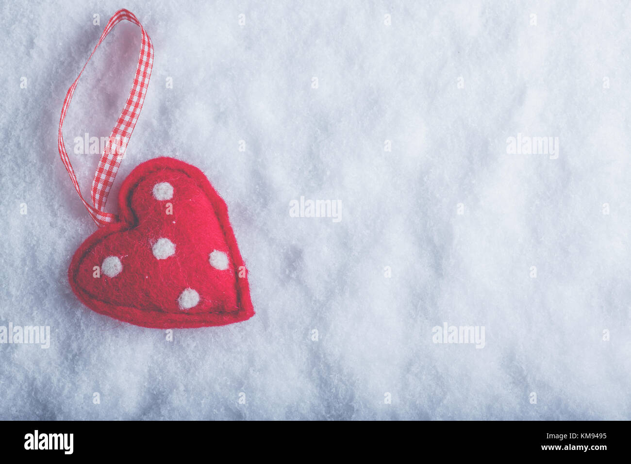 Red toy suave heart on a frosty white snow winter background. Love and ...