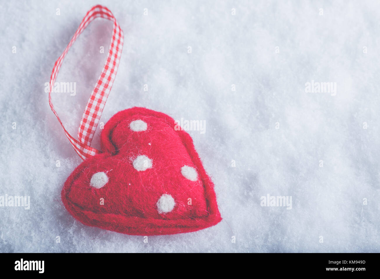 Red toy suave heart on a frosty white snow winter background. Love and ...