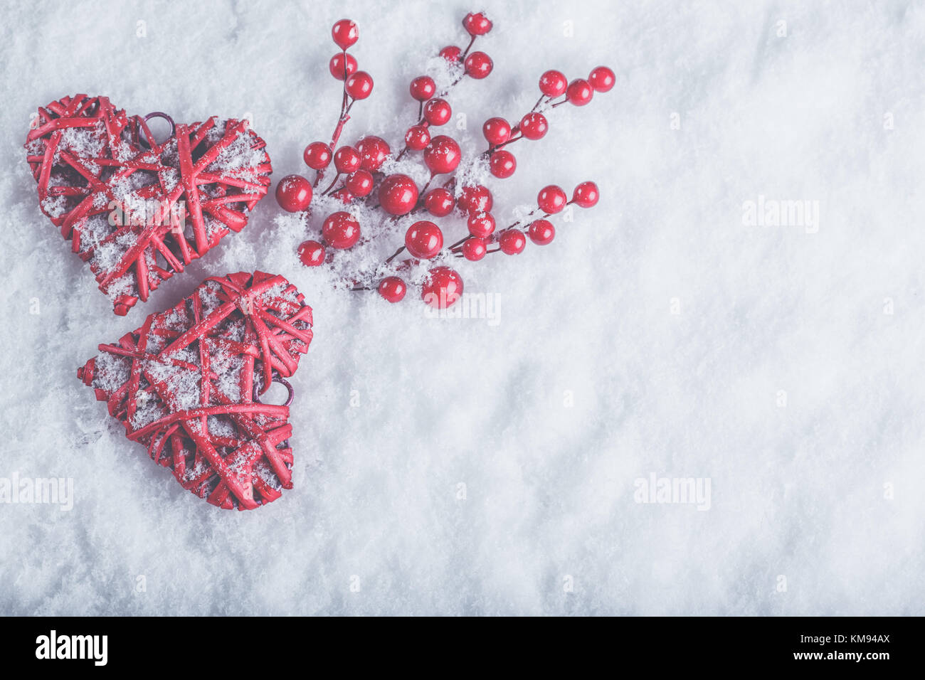 Two beautiful romantic vintage red hearts with mistletoe berries on a ...