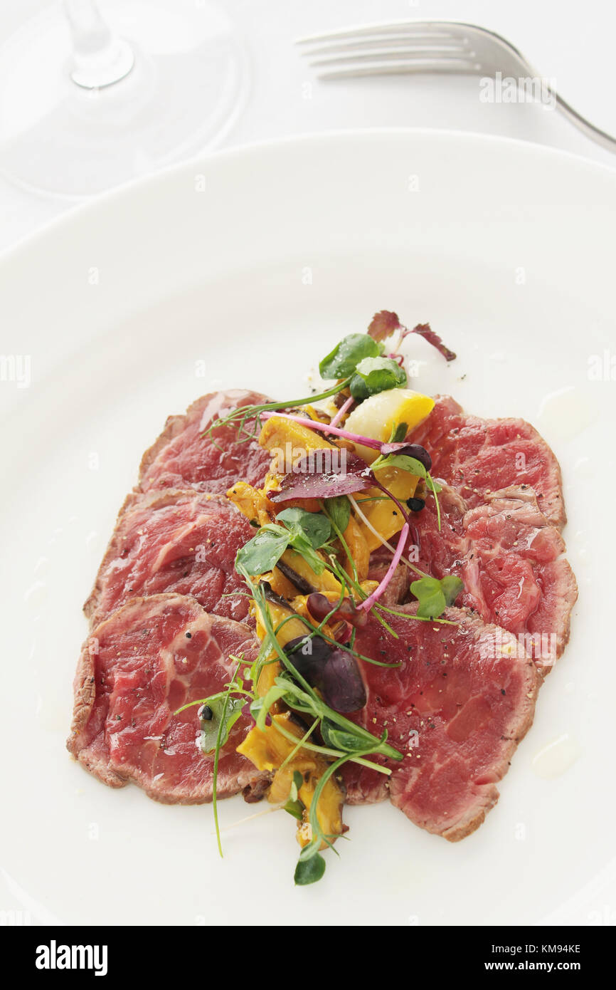 beef carpaccio plated appetizer starter Stock Photo - Alamy