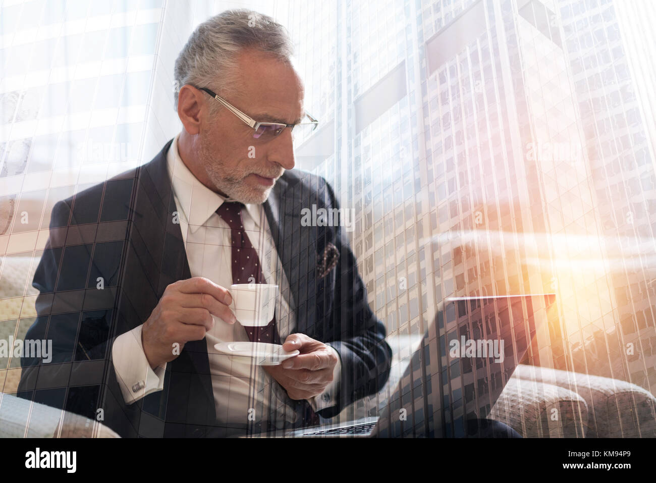 Busy working gentleman drinking coffee at laptop Stock Photo - Alamy