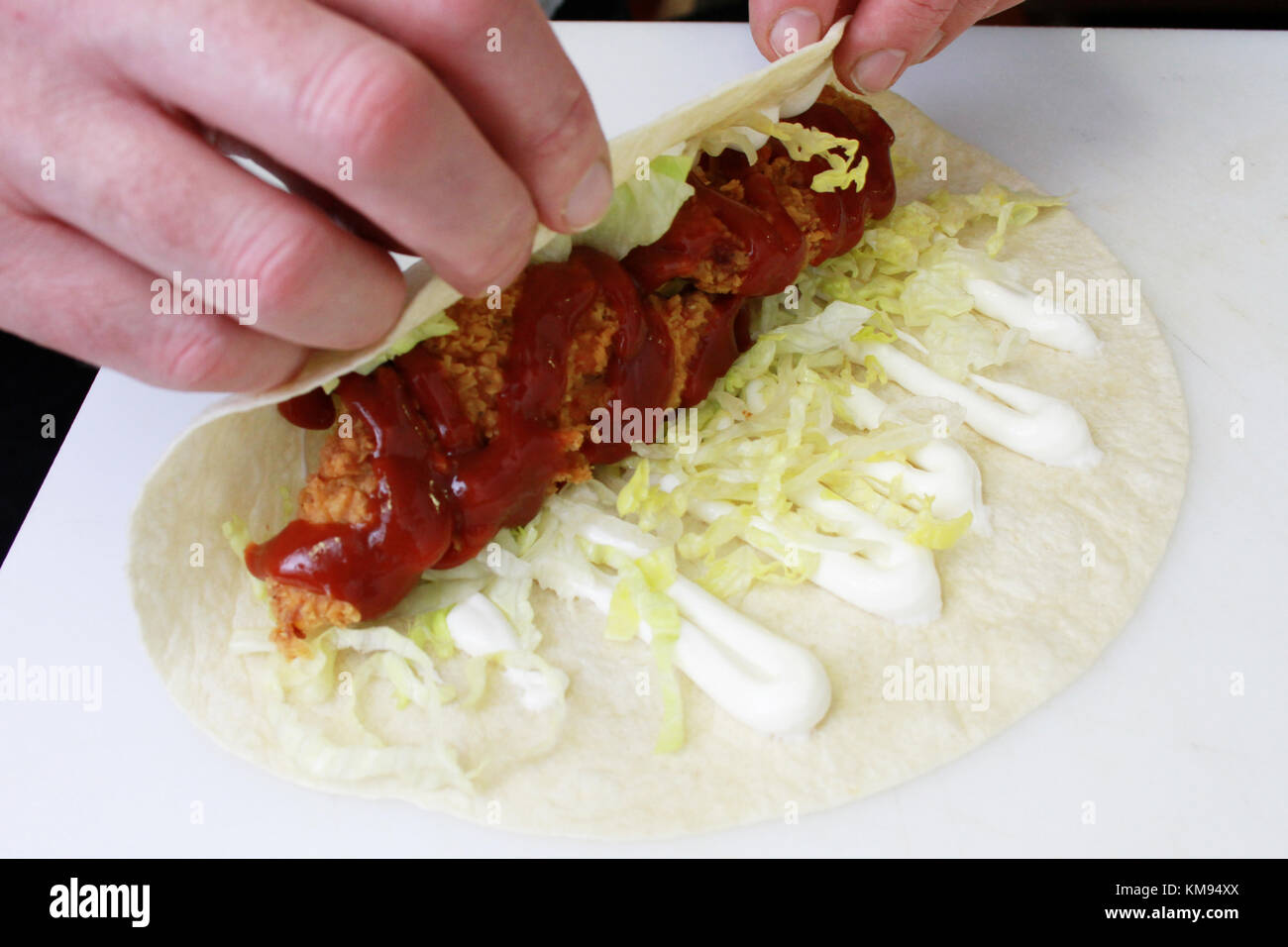 chef preparing chicken wrap Stock Photo - Alamy