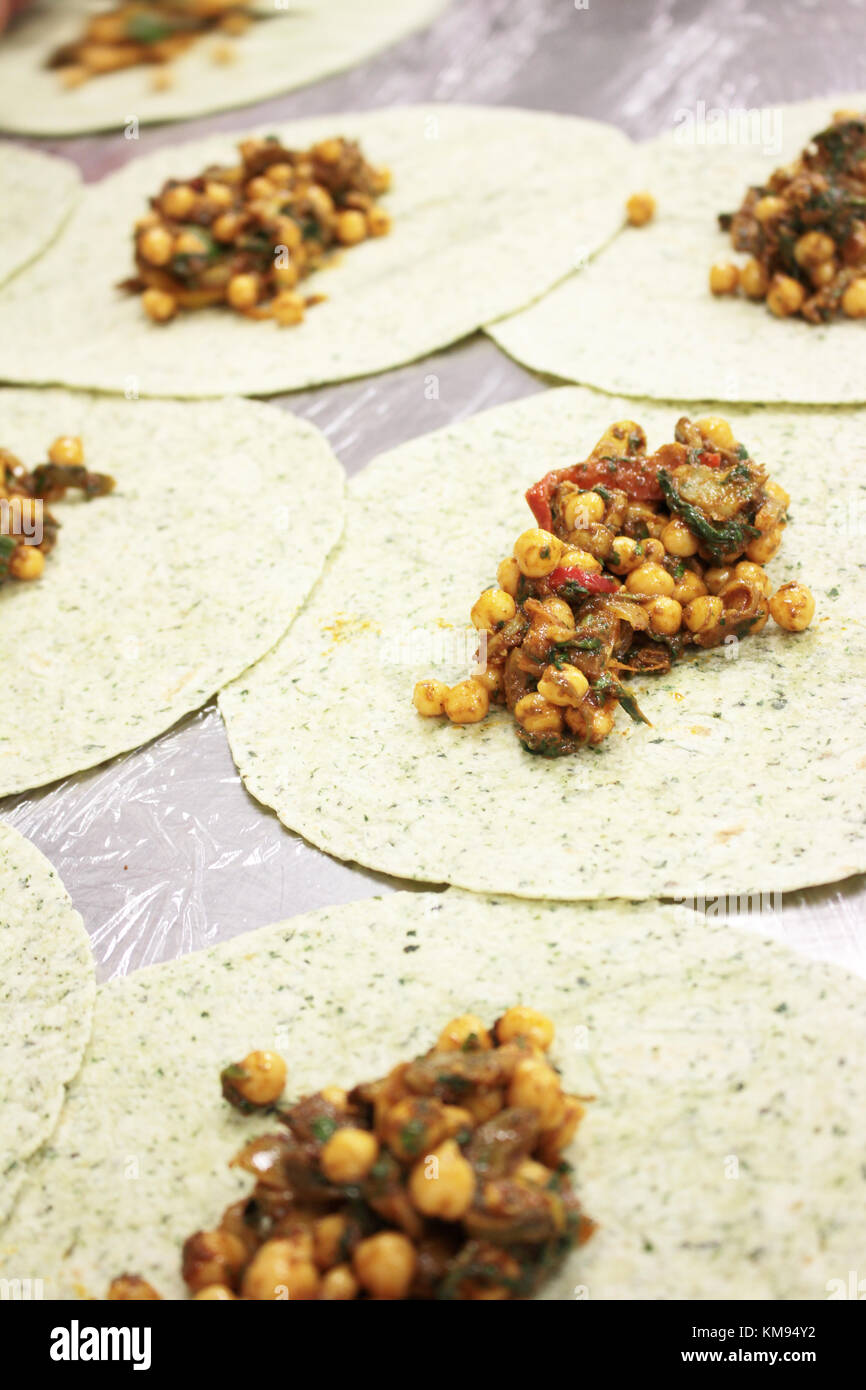 chef preparing indian chick pea wrap Stock Photo - Alamy