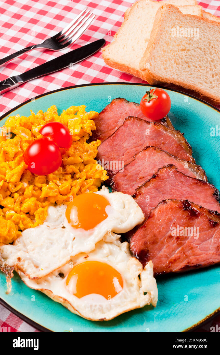 Fried eggs and ham for breakfast. Selective focus on the ham and eggs ...
