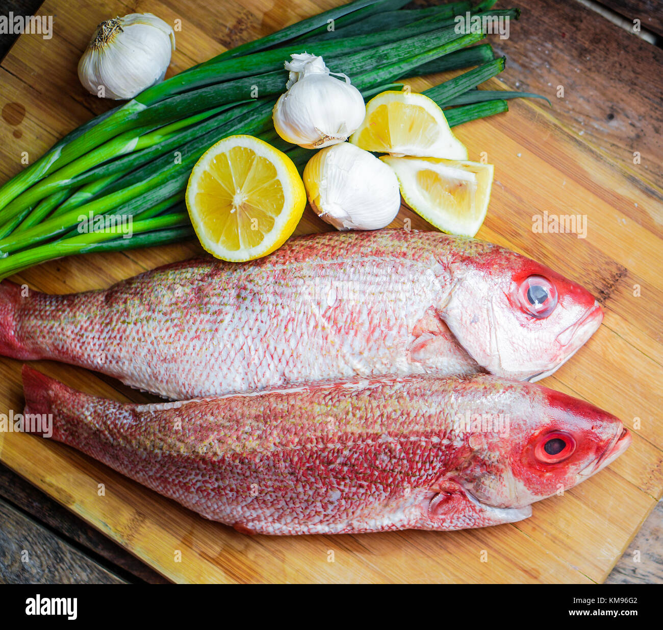 Fresh Red Snapper Preparation With Lemon And Vegetables Stock Photo - Alamy