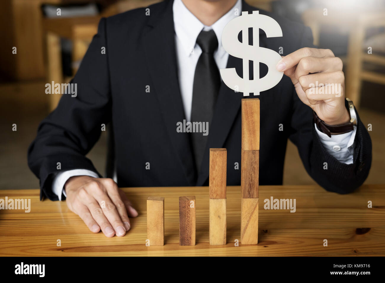 Concept growing value. hand of businessman pick up dollars symbol on ...