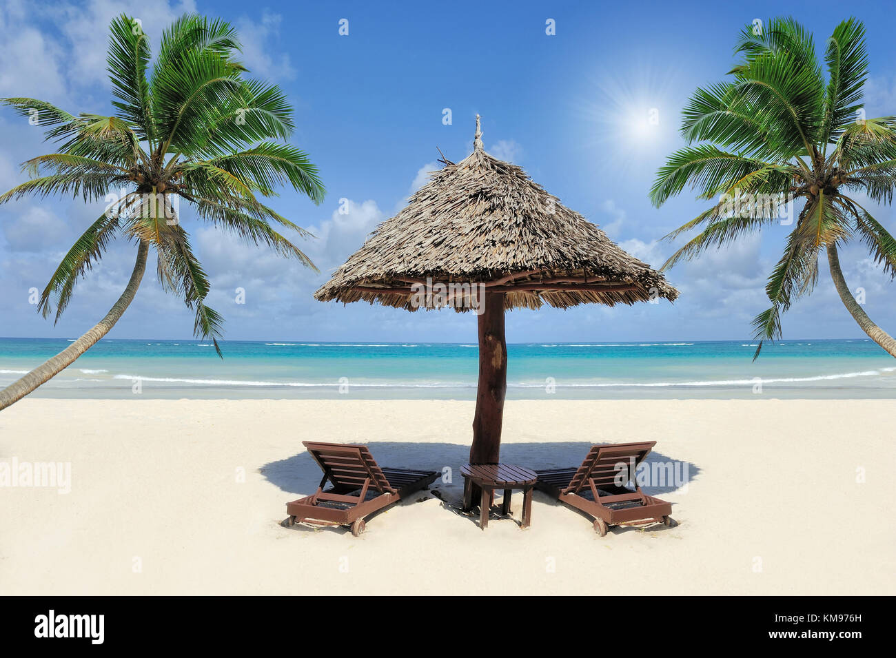 Beautiful tropical beach witn straw umbrella and palm. Straw umbrella ...