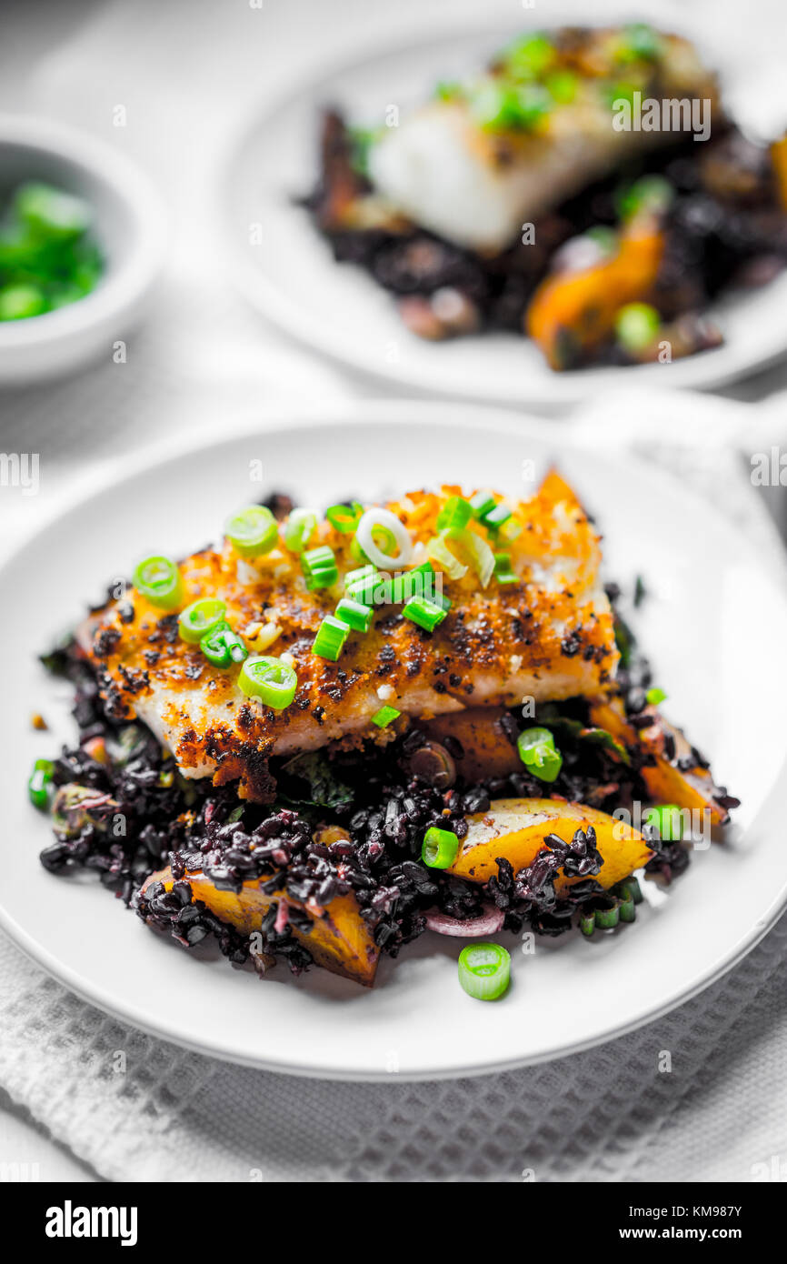 Grilled fish with black rice Stock Photo - Alamy