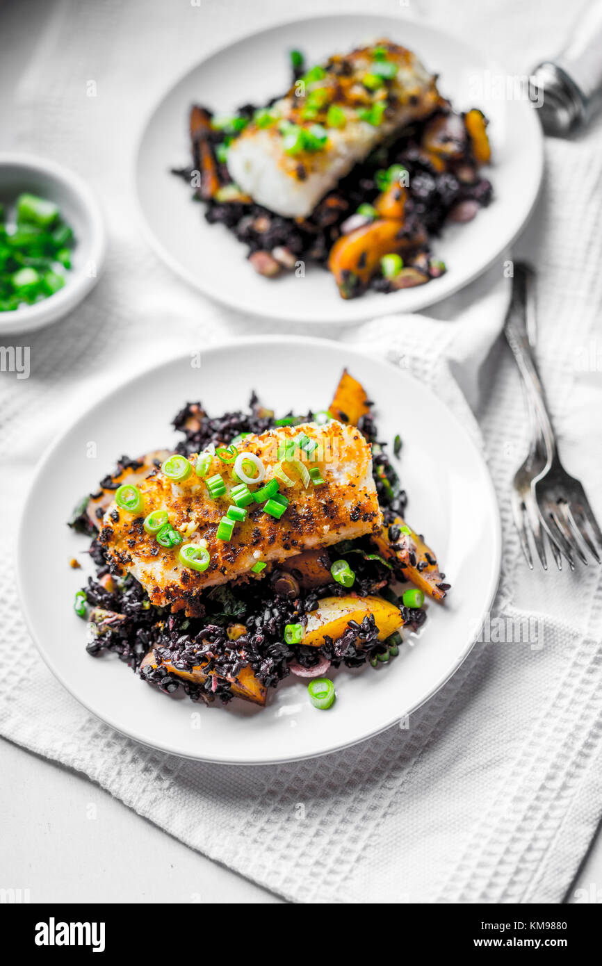 Grilled fish with black rice Stock Photo - Alamy