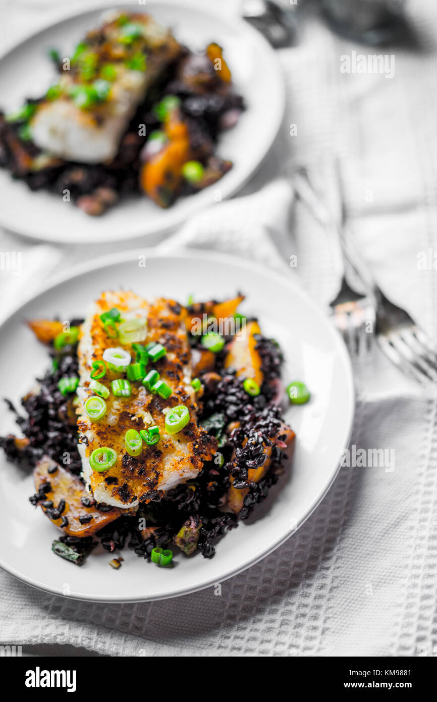 Grilled fish with black rice Stock Photo - Alamy