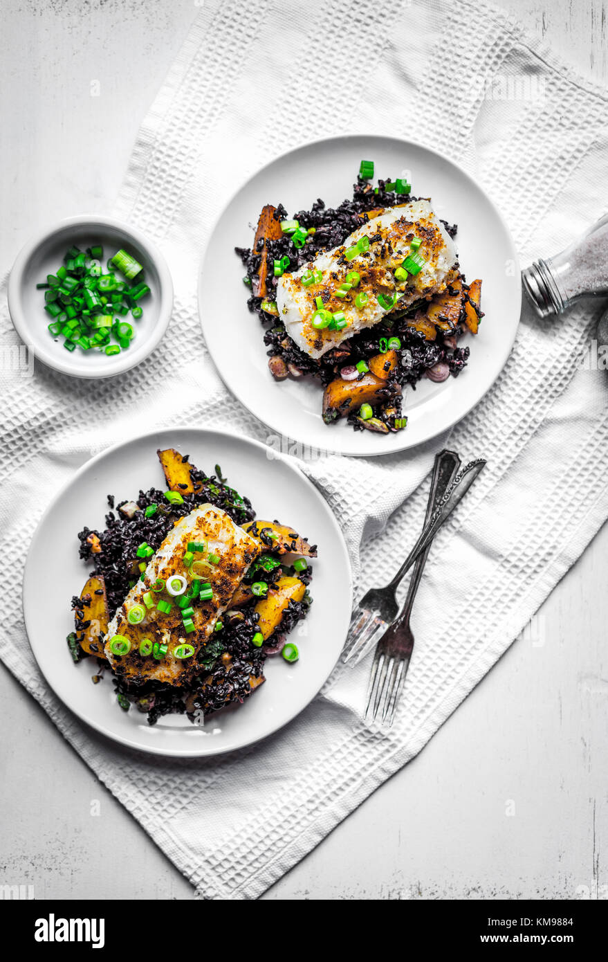 Grilled fish with black rice Stock Photo - Alamy