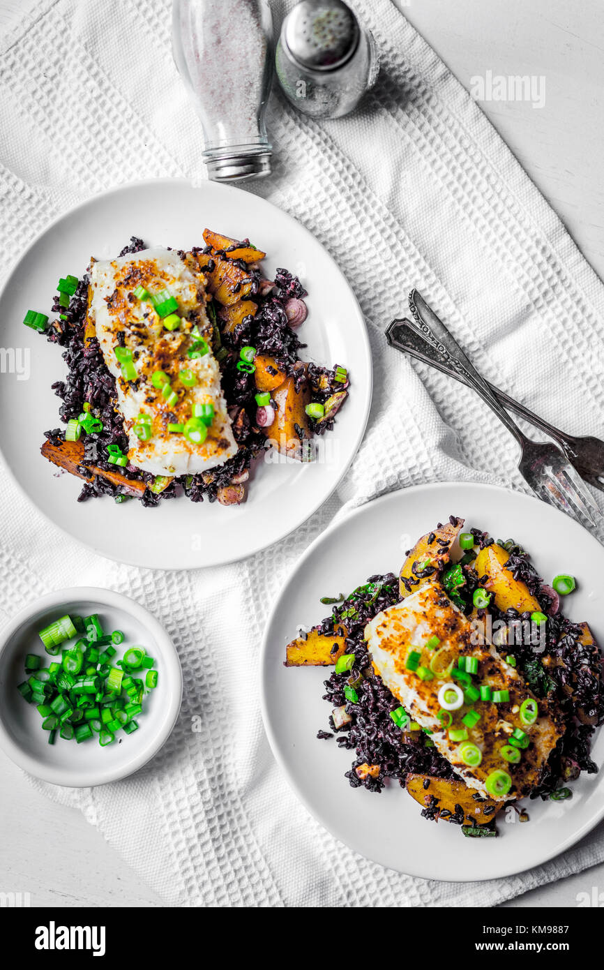 Grilled fish with black rice Stock Photo - Alamy