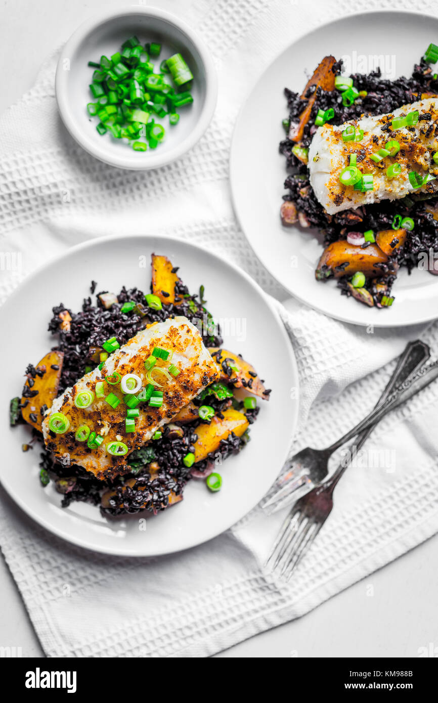 Grilled fish with black rice Stock Photo - Alamy