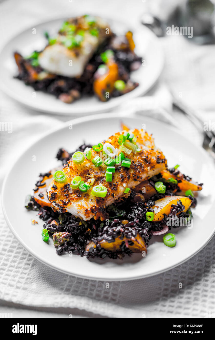 Grilled fish with black rice Stock Photo - Alamy