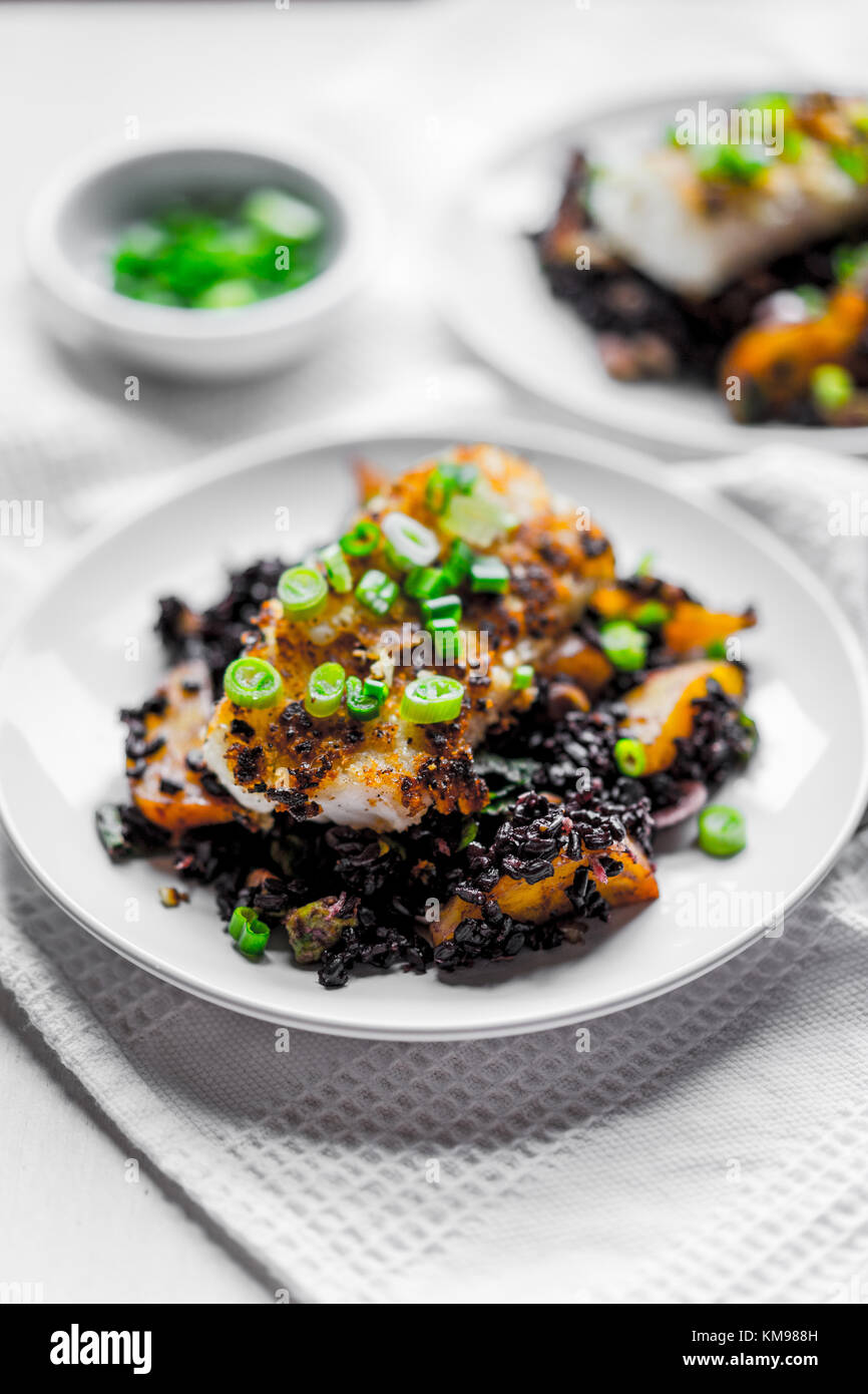 Grilled fish with black rice Stock Photo - Alamy