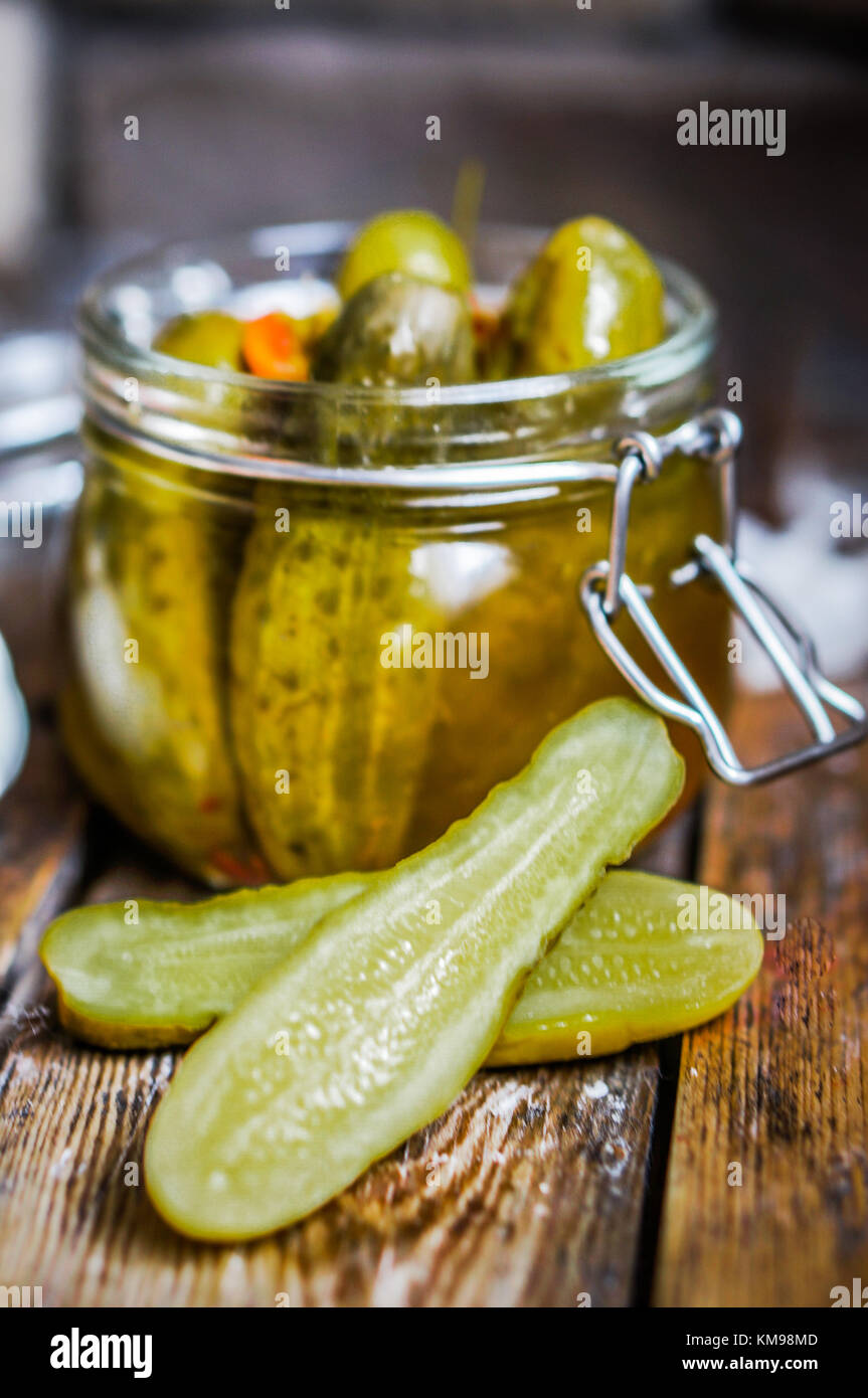 Pickles With Garlic In Glass Jar On Rustic Wooden Background Stock ...