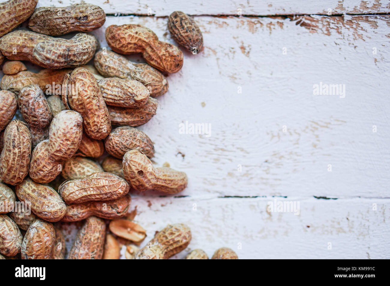 Roasted Peanuts On White Wooden Background Stock Photo - Alamy