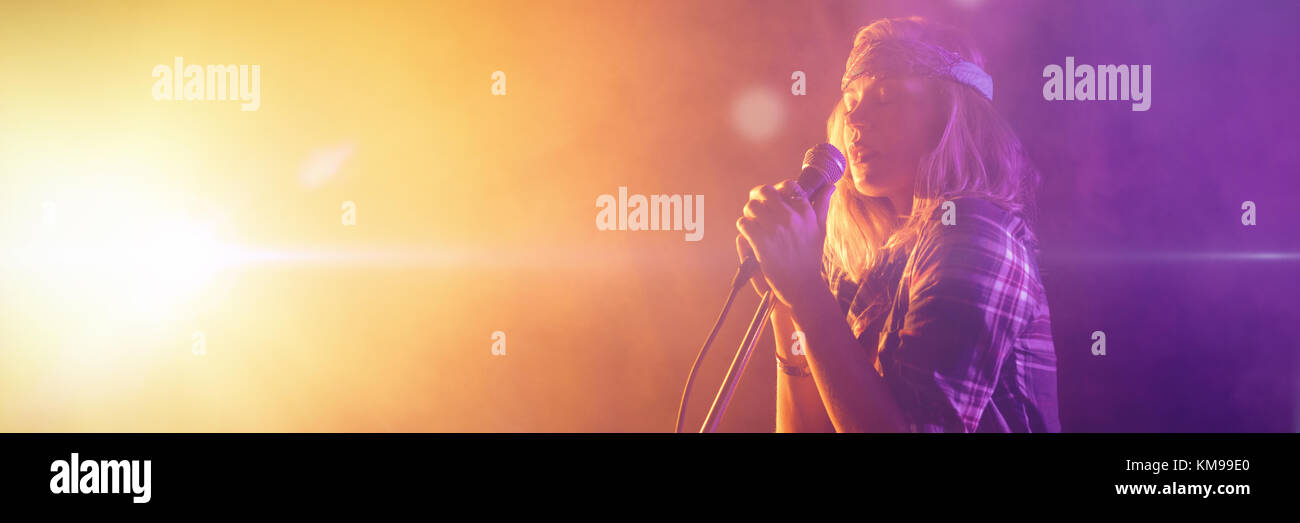 Female singer performing at concert in nightclub Stock Photo - Alamy