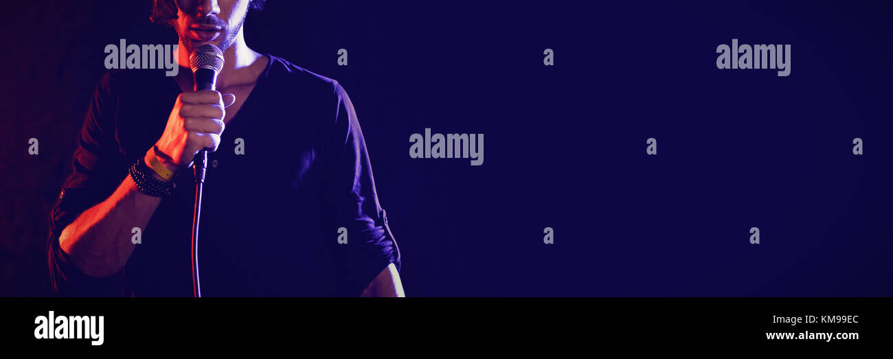 Microphone standing holding arts culture and entertainment musical ...