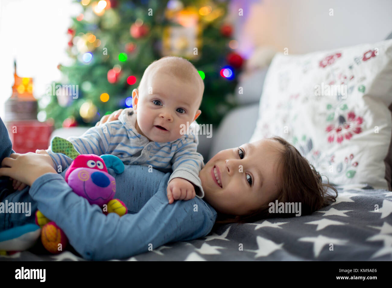 Six years old preschool boy, playing at home with his newborn baby ...