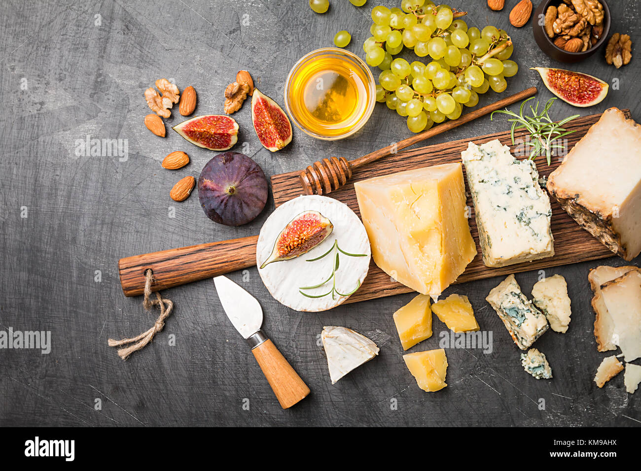 various types of cheese on wooden cutting board, top view Stock Photo ...