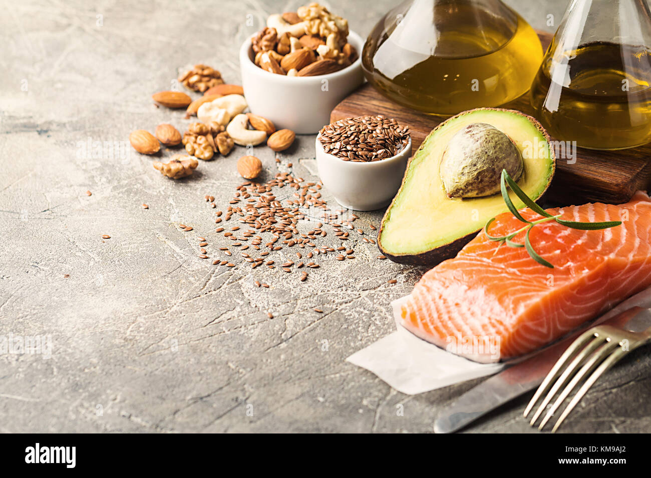 Healthy fats in nutrition - salmon, avocado, oil, nuts. Concept of ...