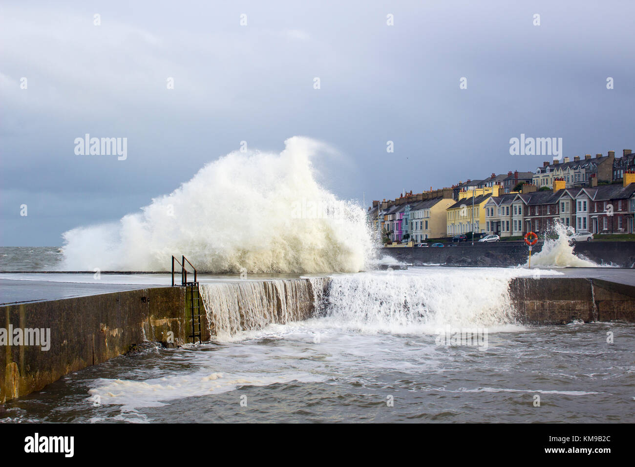 Fierce waves braking on the quayside of the Long Hole natural harbour ...
