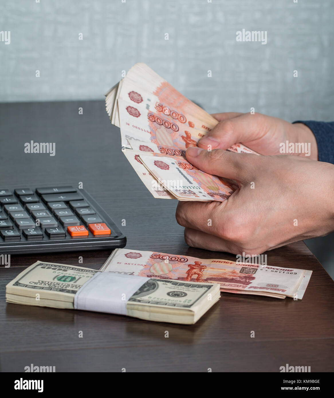 Man's hands with money and calculator. Money saving concept Stock Photo ...