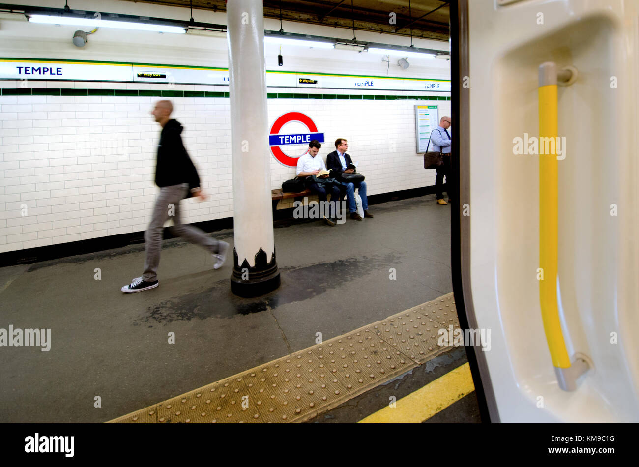 London, England, UK. Temple underground station - men on the platform ...