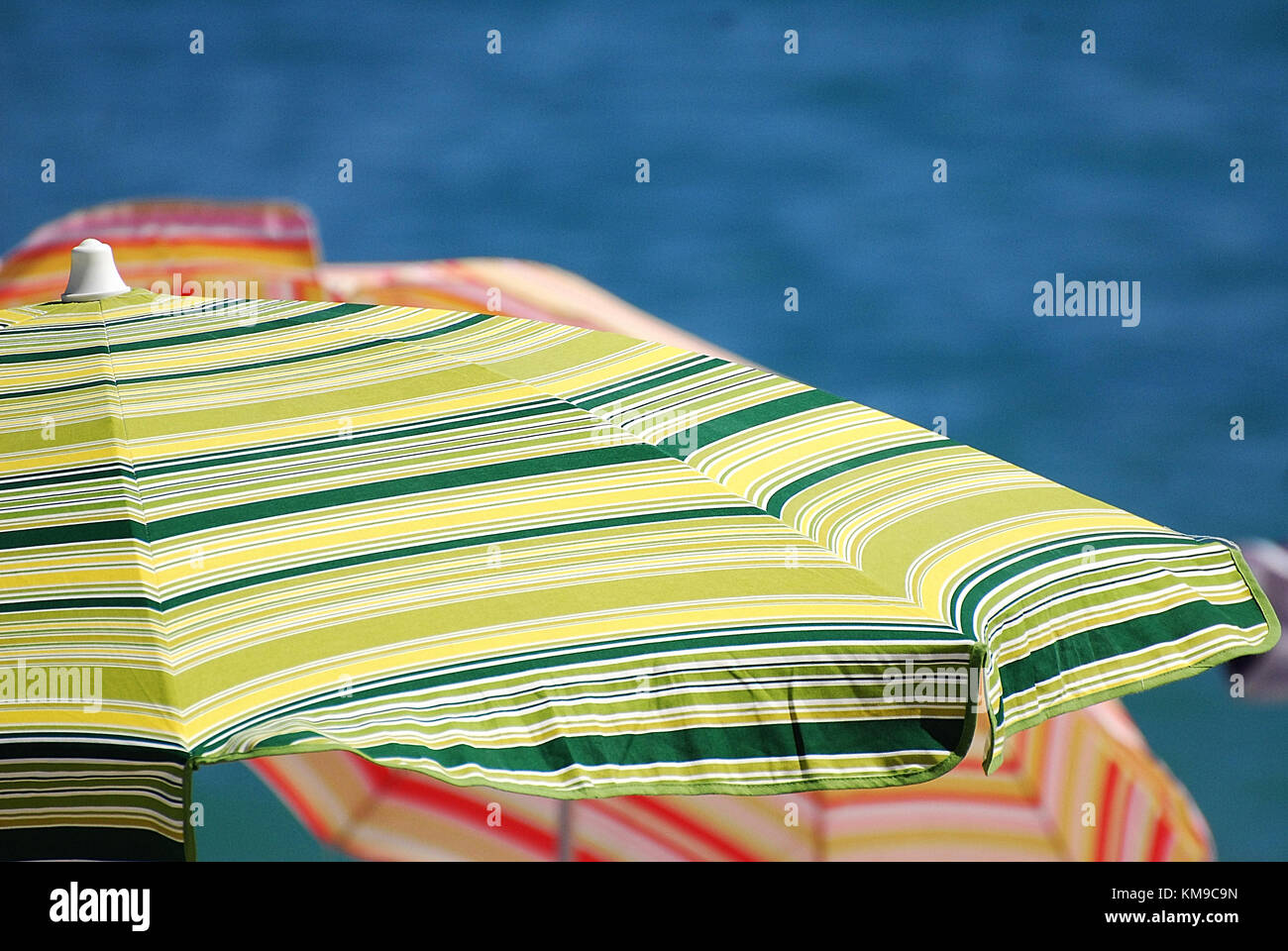 Striped Parasol at the seaside Stock Photo - Alamy