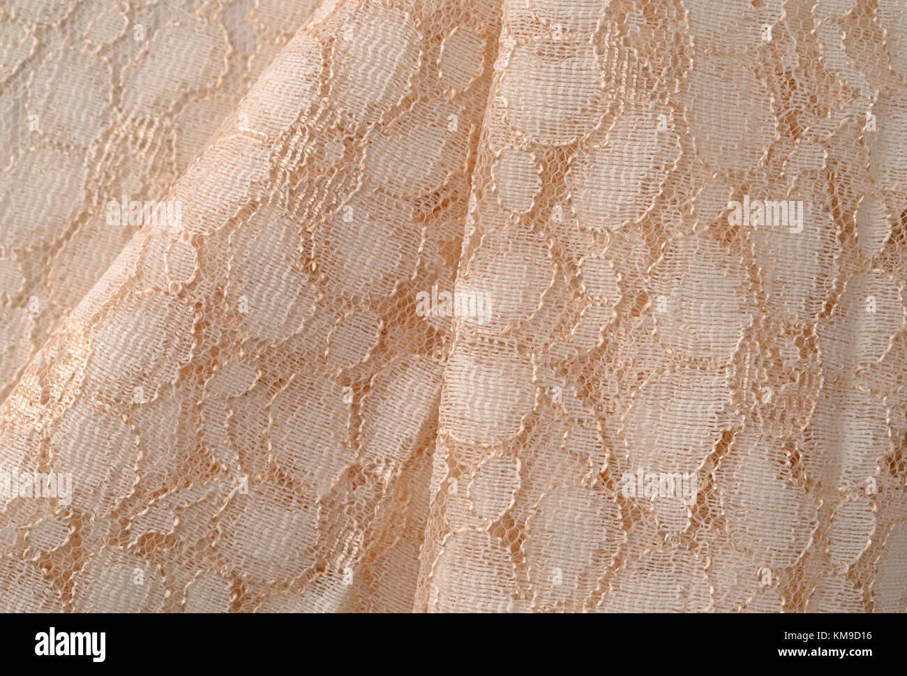 A length of antique folded lacy sheer fabric with a floral motif Stock ...