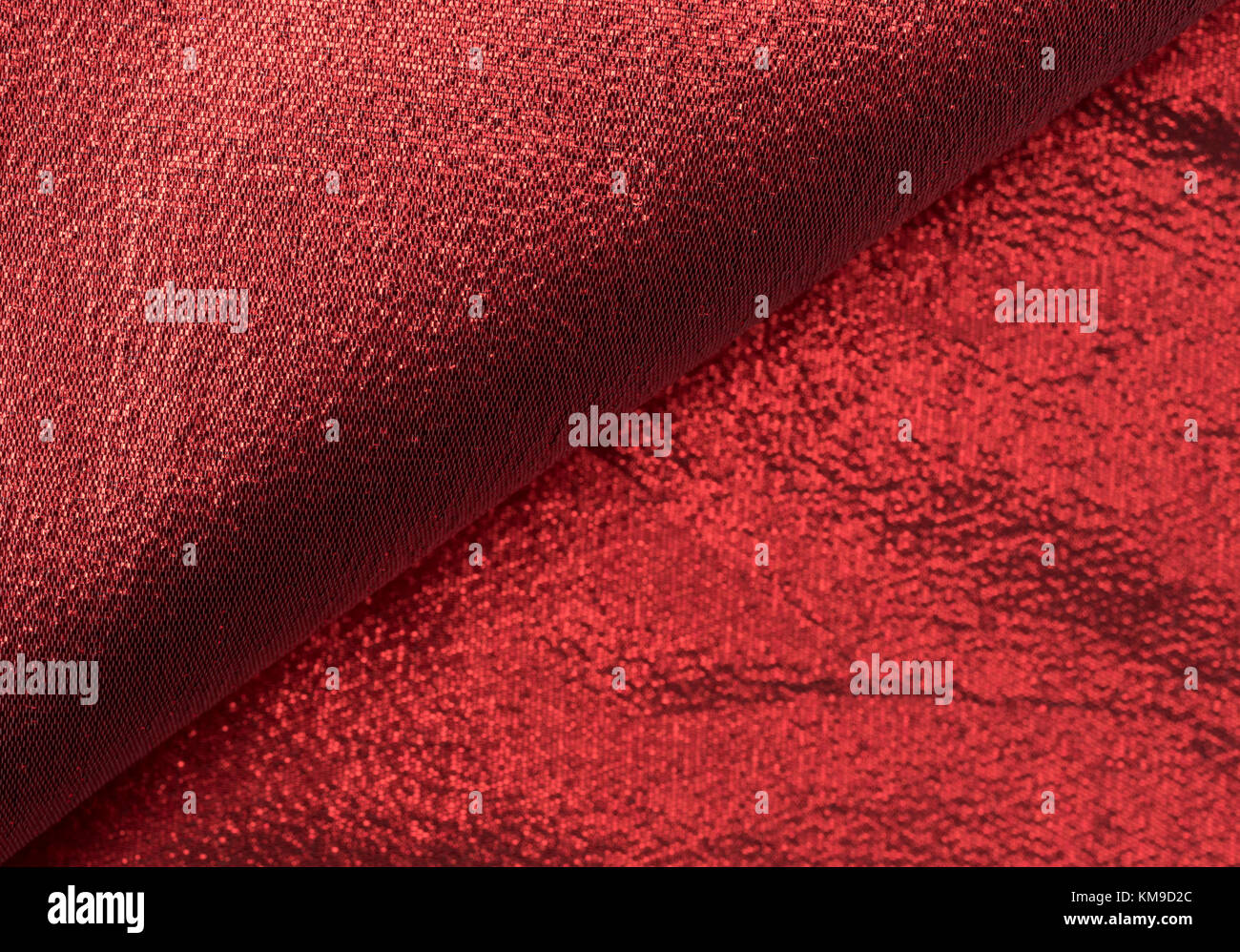 A piece of red metallic cloth folded showing the backing Stock Photo ...