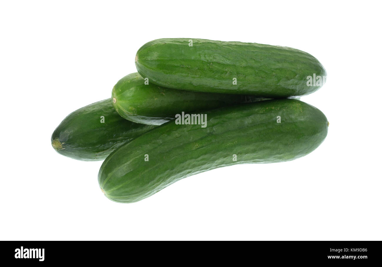 Four small bite size dipping cucumbers isolated on white background ...