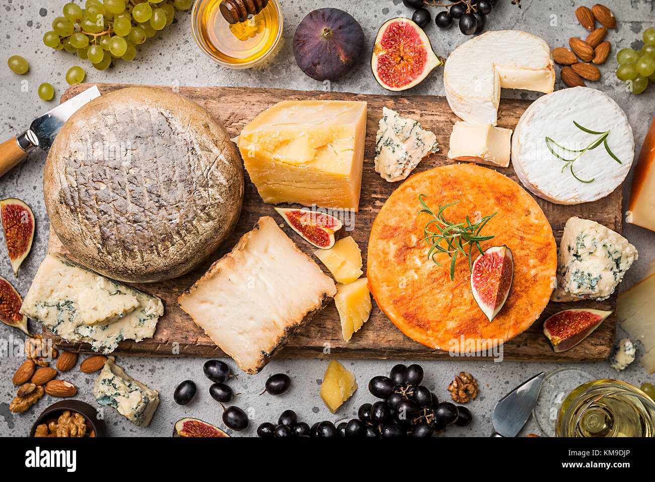various types of cheese on wooden cutting board, top view Stock Photo ...