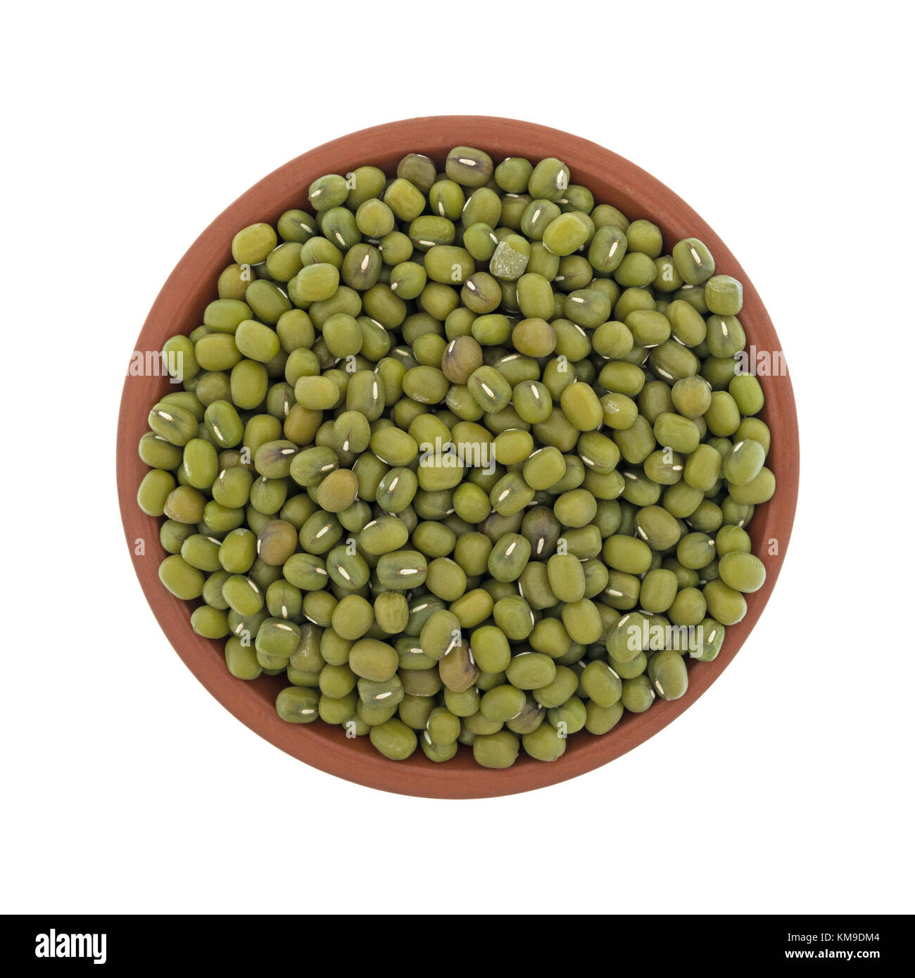 Top view of a portion of organic mung beans in a small terracotta bowl ...