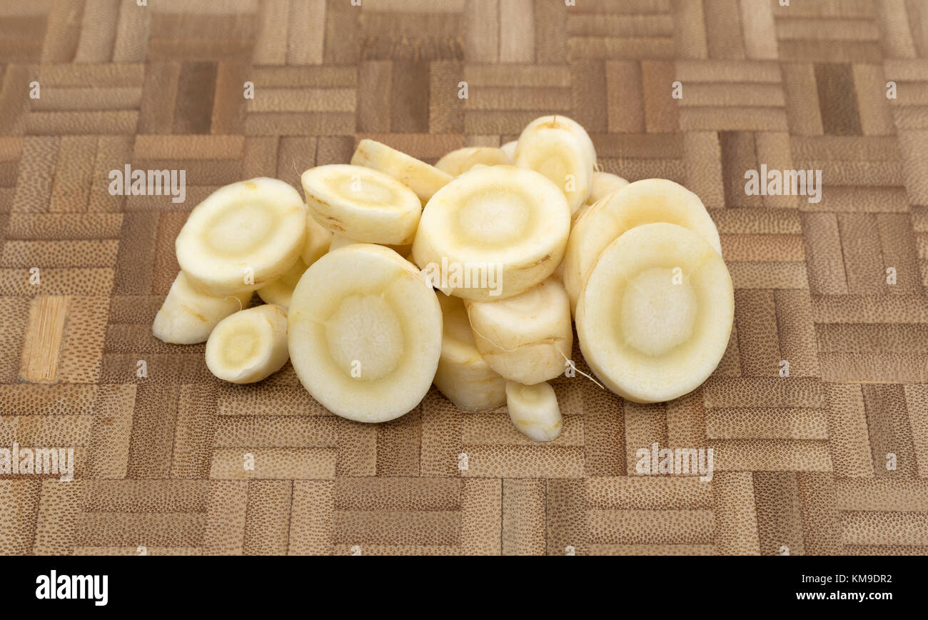A small portion of sliced parsnip on a wood cutting board Stock Photo ...