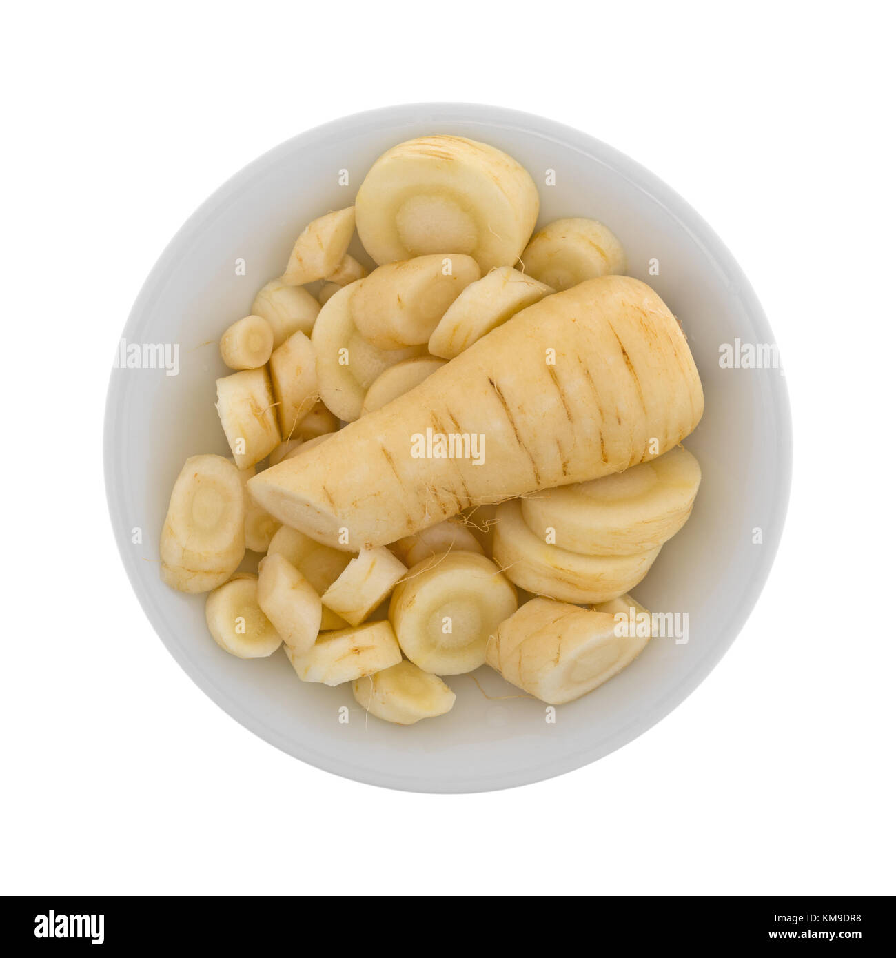 Top view of a bowl filled with parsnip and slices isolated on a white ...
